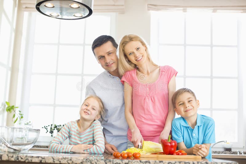 Portrait of Happy Family Preparing Food in Kitchen Stock Photo - Image ...
