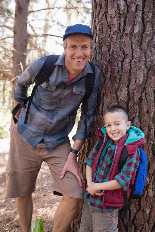 Portrait of Happy Father and Son Leaning on Tree Trunk Stock Image ...