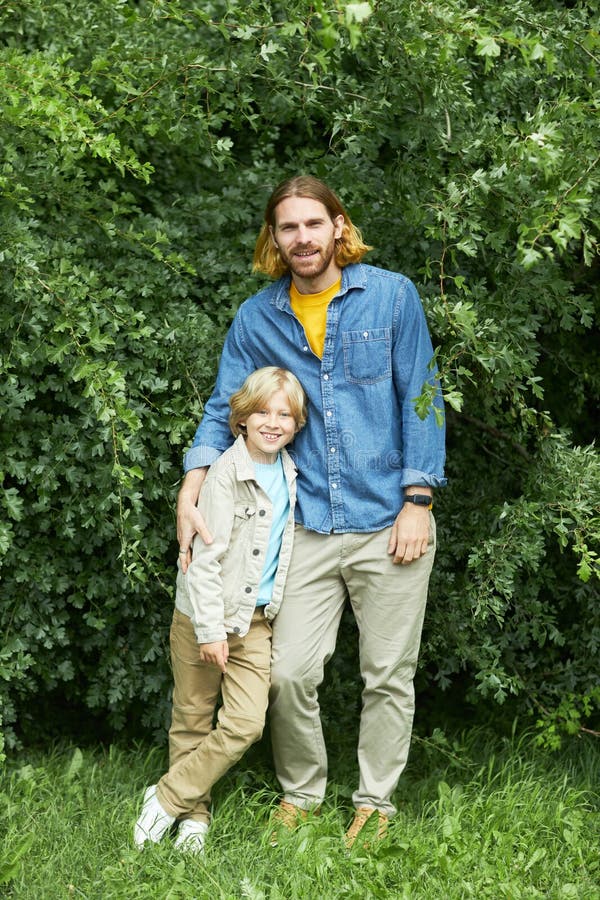 Portrait of Happy Father and Son Standing Against Greenery in Park ...