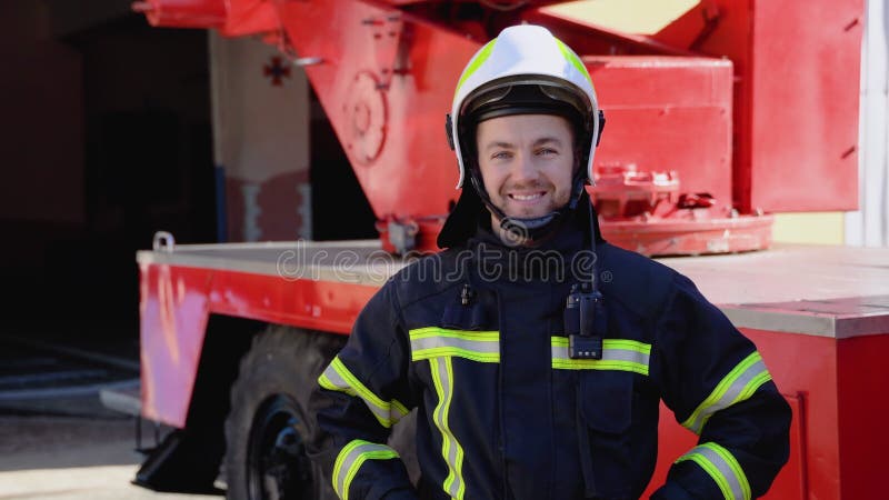 Portrait of Happy Fireman with Helmet Near Fire Engine. Firefighter ...