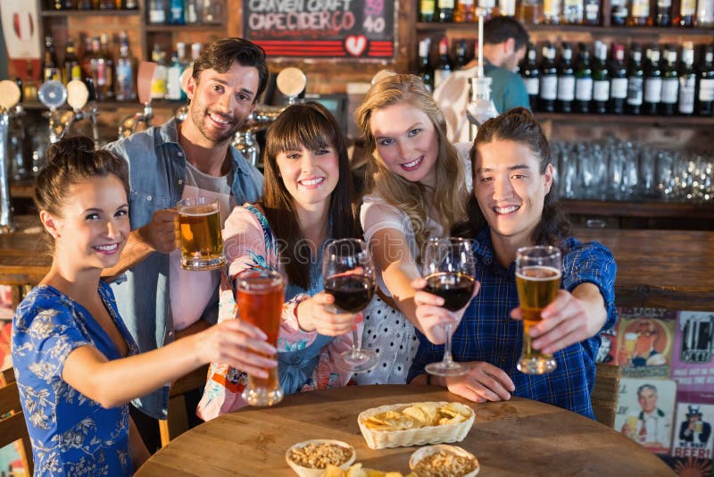 Portrait of Happy Friends Holding Drinks in Bar Stock Photo - Image of ...