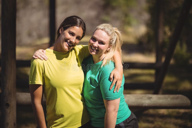 Portrait of Happy Friends Standing with Arms Around during Obstacle ...