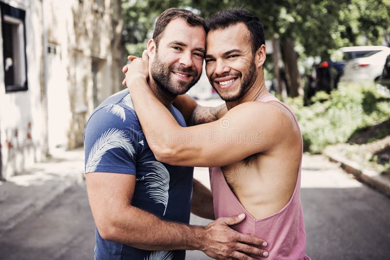 A Portrait Of A Happy Gay Couple Outdoors In Urban Background Stock
