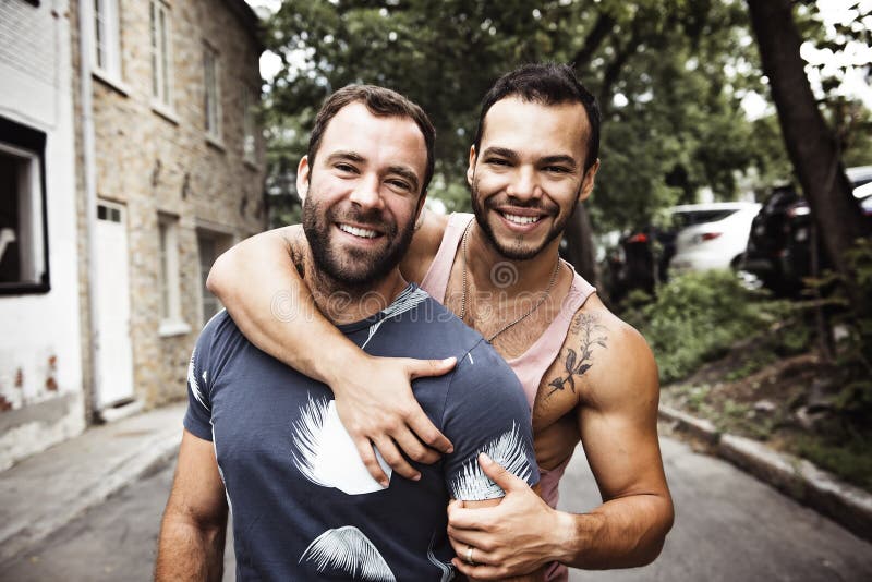 A Portrait Of A Happy Gay Couple Outdoors In Urban Background Stock