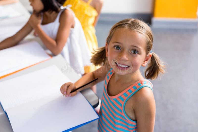 Portrait of Happy Girl Writing on Book Stock Photo - Image of choice ...
