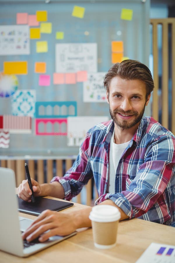 Portrait of Happy Graphic Designer Using Laptop and Graphic Tablet ...