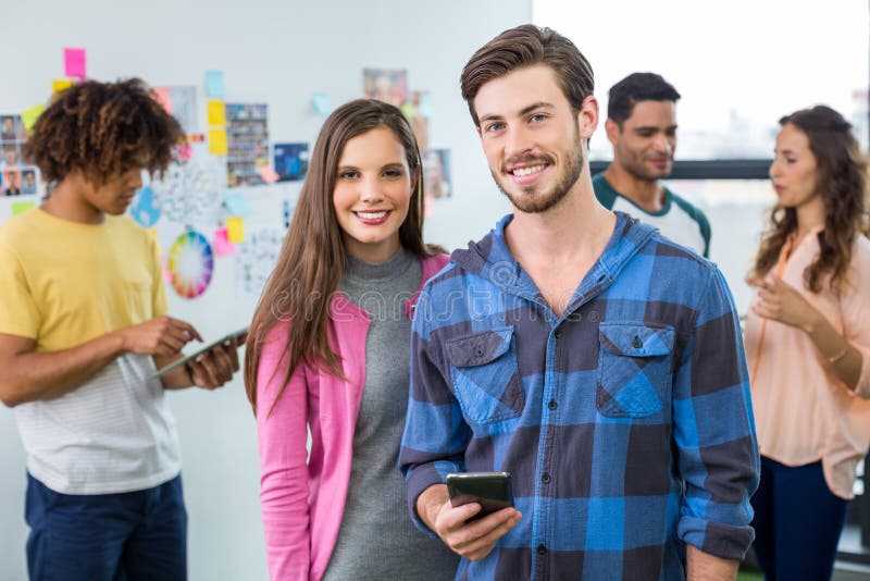 Portrait of Happy Graphic Designers Using Mobile Phone Stock Photo ...
