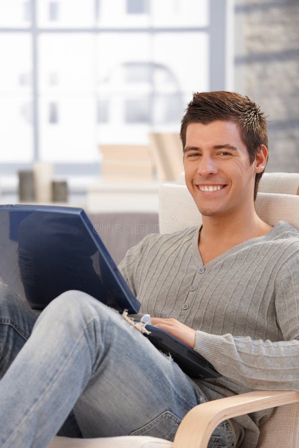 Smiling Guy Using Laptop Computer Stock Photo - Image of adult, indoors ...