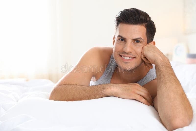 Portrait of Happy Handsome Man Lying on Bed Stock Image - Image of ...