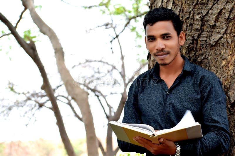 Portrait of Happy Young Man Reading Book Outdoor Stock Photo - Image of ... Portrait of Happy Young Man Reading Book Outdoor Stock Photo - Image of ...
