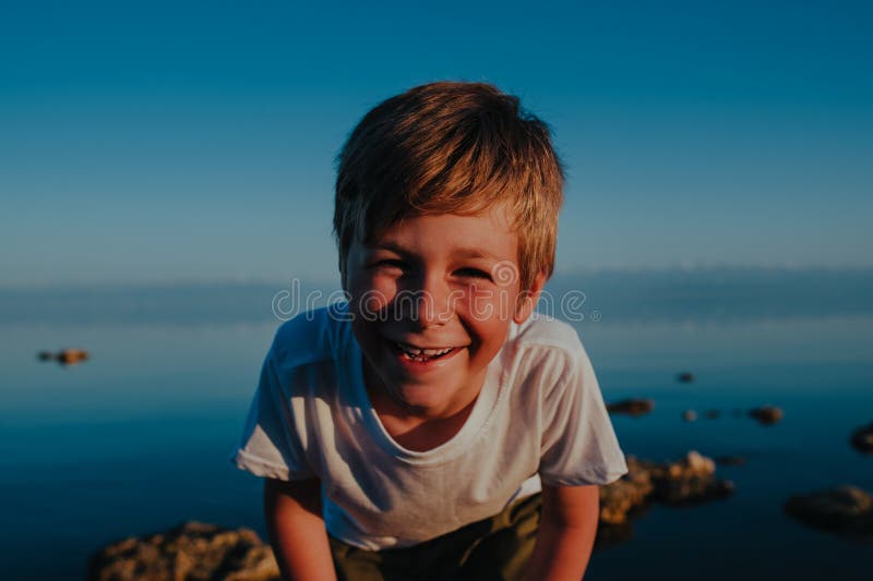 Portrait of Happy Boy on Lake Shore at Sunset Stock Image - Image of ...