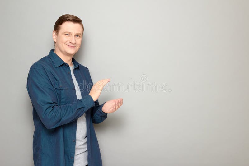 Portrait Of Happy Man Clapping His Hands And Smiling Cheerfully Stock