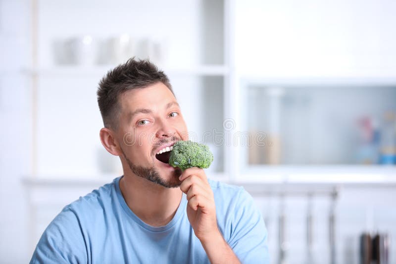 Portrait of Happy Man Eating Broccoli Stock Photo - Image of adult ...