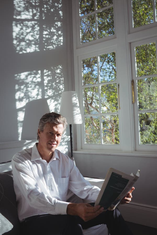 Portrait of Happy Man Reading Magazine Stock Photo - Image of leisure ...