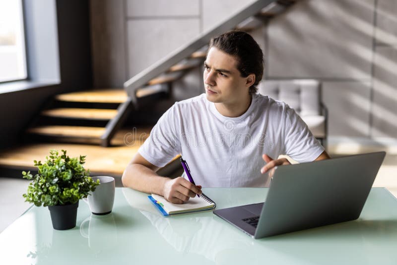 Portrait of a Happy Man Taking Notes at Home Look at Laptop Stock Image ...