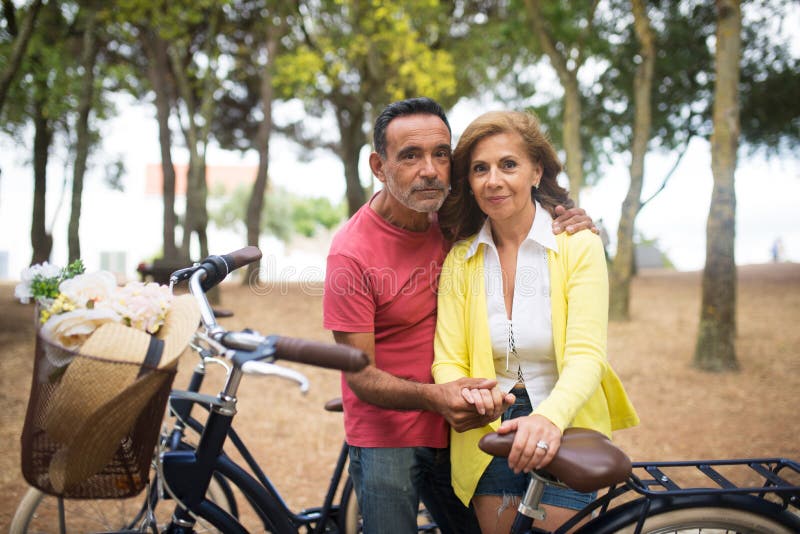 Portrait Of Happy Mature Couple Cycling In Park Stock Image Image Of
