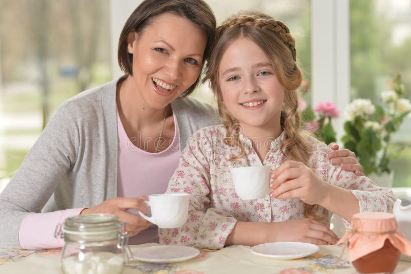 Happy Mom and Daughter Drinking Tea at Home Stock Photo - Image of ...