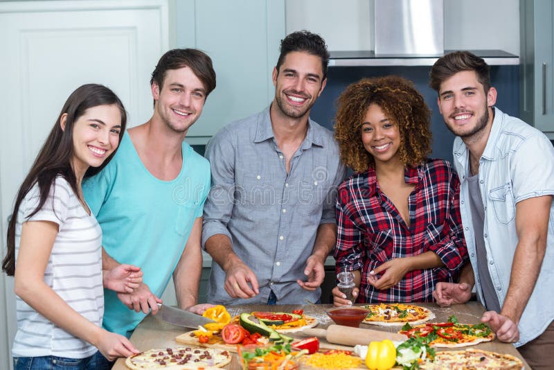Portrait of Happy Multi-ethnic Friends Preparing Pizza at Home Stock ...