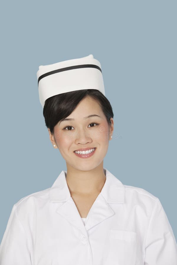 Midsection of a Female Doctor Reading Medical Report Over Light Blue ...