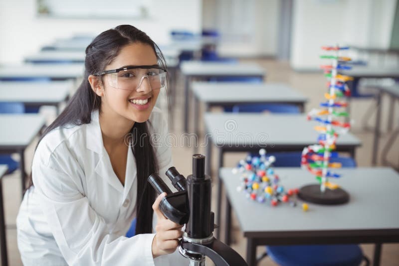 Boy Holding Microscope Smiling in Front of Classroom Stock Photo ...