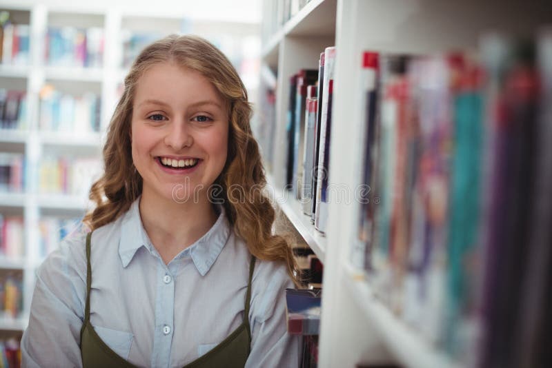 Portrait of Happy Schoolgirl Standing in Library Stock Photo - Image of ...