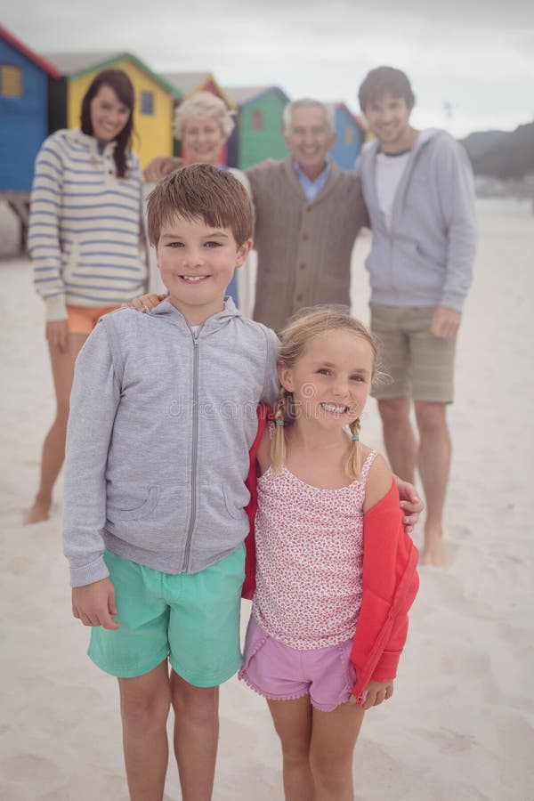 Portrait of Happy Siblings Standing with Parents in Background Stock ...
