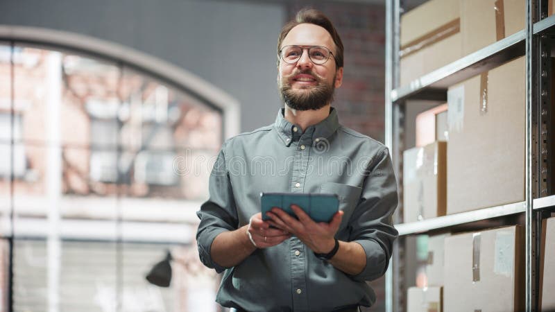 Portrait of a Happy Small Warehouse Employee Checking Inventory, Using ...
