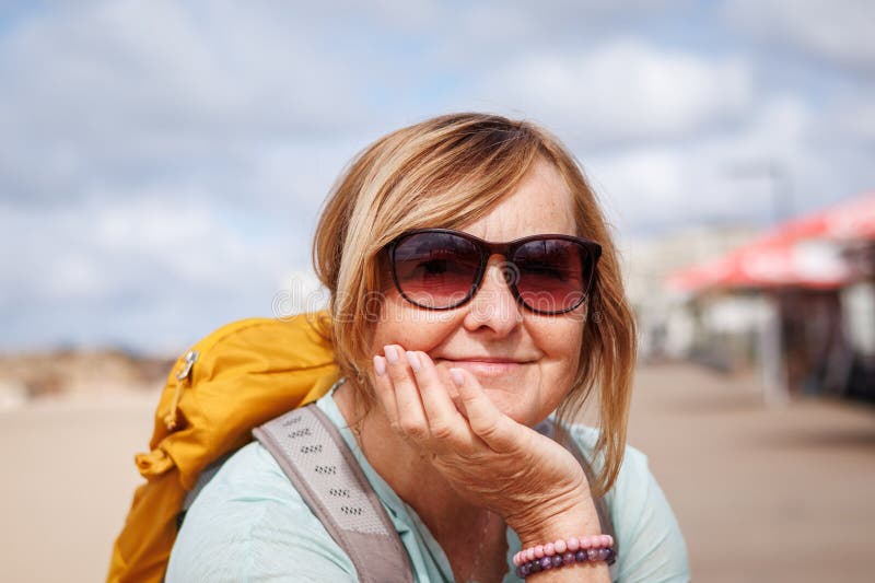 Portrait Of Happy Smiling Mature Woman Tourist With Sunglasses And