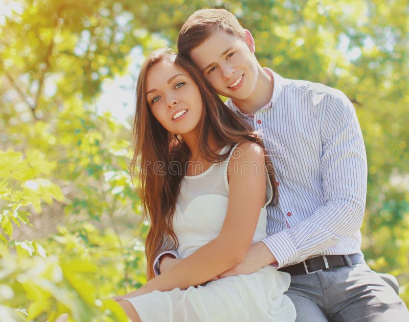 Portrait Of Happy Smiling Young Couple Together Outdoors In Park Stock