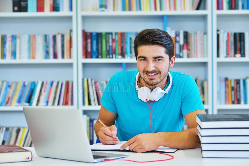 Portrait of Happy Student while Reading Book in School Library. Stock ...