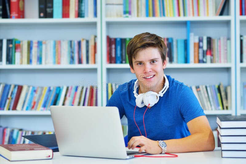 Portrait of Happy Student while Reading Book in School Library. Stock ...