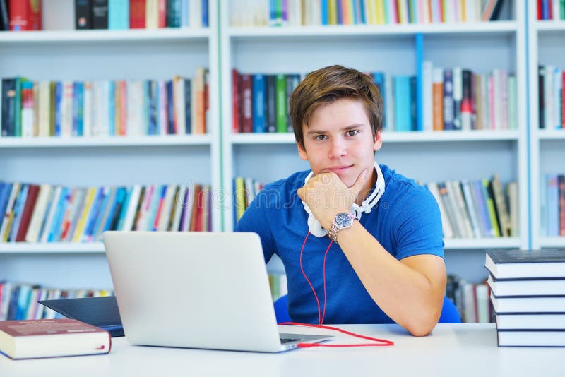Portrait of Happy Student while Reading Book in School Library. Stock ...