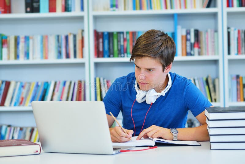 Portrait of Happy Student while Reading Book in School Library. Stock ...