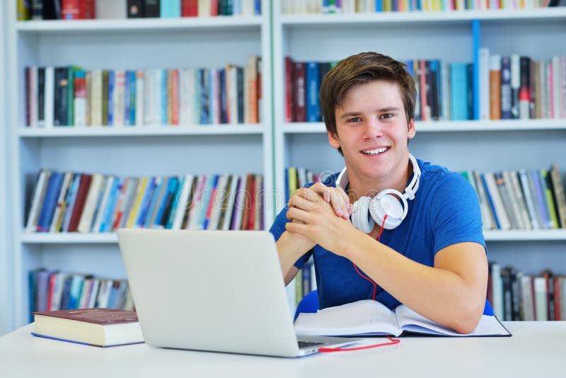Portrait of Happy Student while Reading Book in School Library. Stock ...