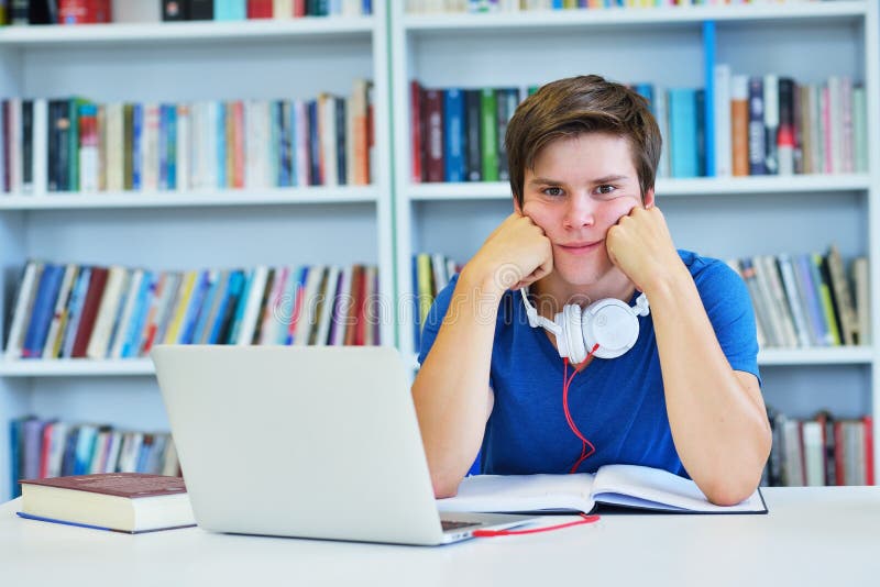 Portrait of Happy Student while Reading Book in School Library. Stock ...
