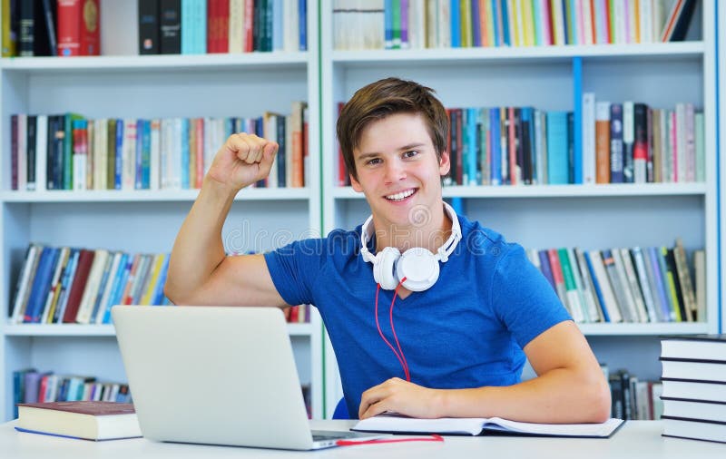 Portrait of Happy Student while Reading Book in School Library. Stock ...