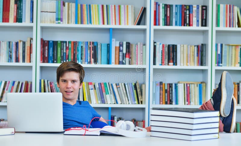 Portrait of Happy Student while Reading Book in School Library. Stock ...