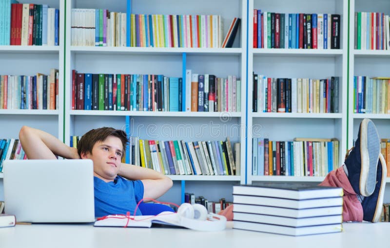 Portrait of Happy Student while Reading Book in School Library. Stock ...