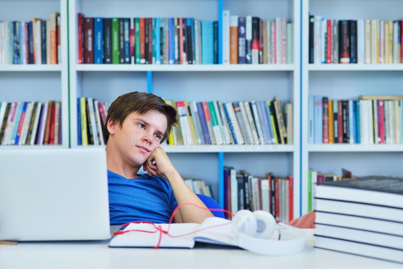 Portrait of Happy Student while Reading Book in School Library. Stock ...