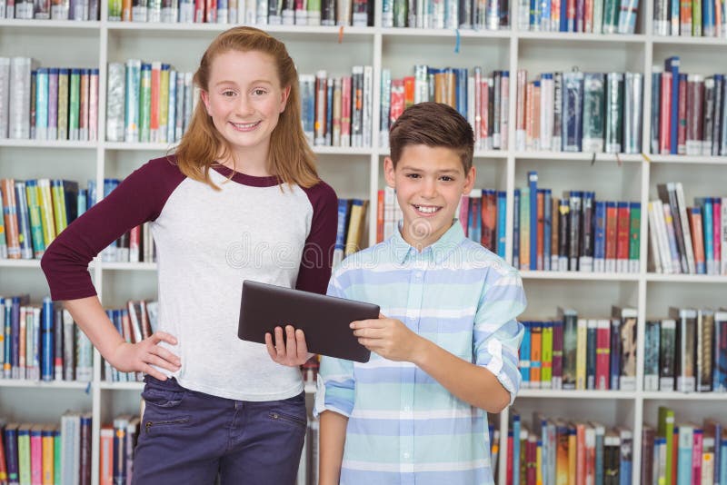 Portrait of Happy Students Holding Digital Tablet in Library Stock ...
