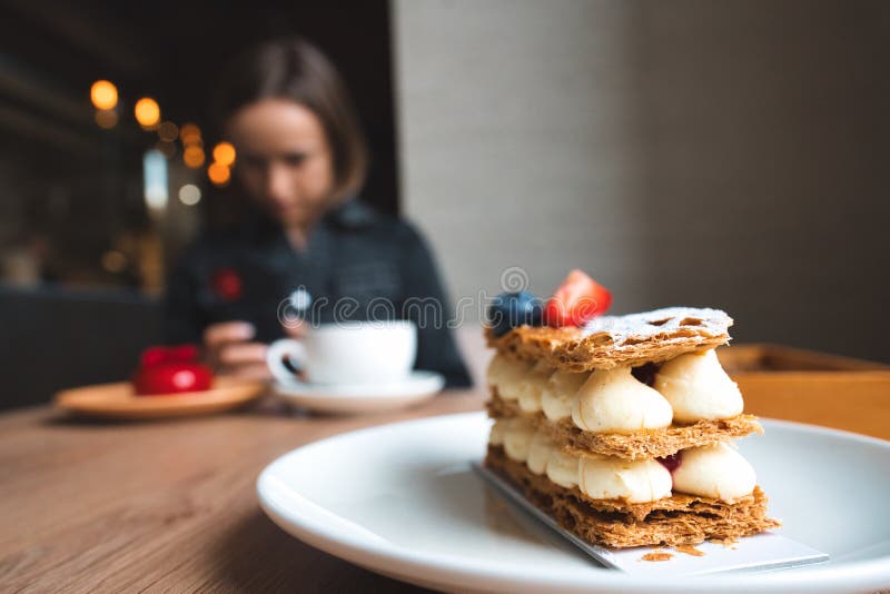 Portrait Of A Happy Woman Eating A Piece Of Cake And Drinking Coffee