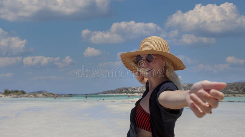 Portrait Of Happy Woman With Straw Hat Smiling On The Beach On Crete