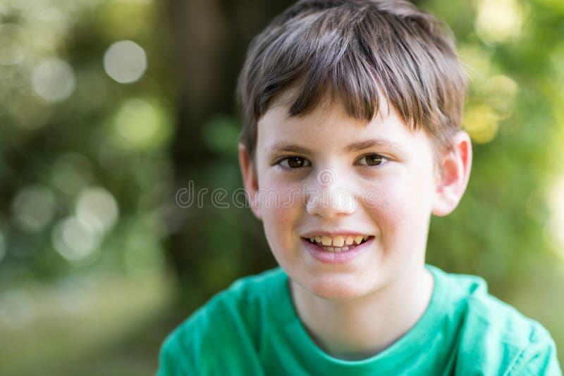 Portrait of Happy Young Boy Sitting Outdoors Stock Photo - Image of ...