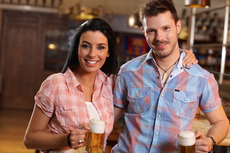 Portrait of Happy Young Couple in Pub Stock Image - Image of drinking ...