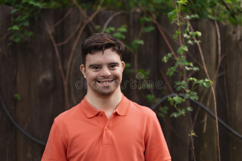 Portrait of Happy Young Man with Down Syndrome Standing Outdoors in ... Portrait of Happy Young Man with Down Syndrome Standing Outdoors in ...