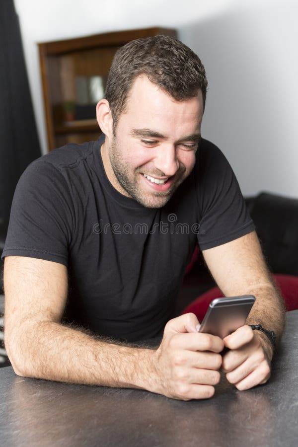 Portrait of Happy Young Man at Home Stock Photo - Image of phone ...