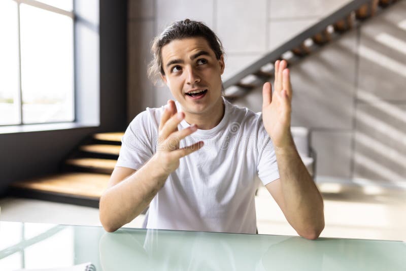 Portrait Happy Young Man Waving Hand, Looking at Camera, Greeting ... Portrait Happy Young Man Waving Hand, Looking at Camera, Greeting ...