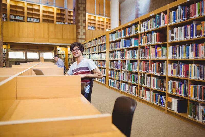 Portrait of Happy Young Student Using His Laptop in Library Stock Image ...