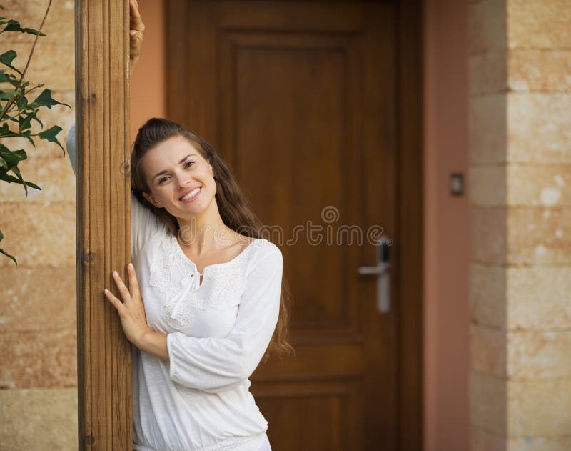 Portrait of Happy Young Woman at Doorstep Stock Image - Image of ...