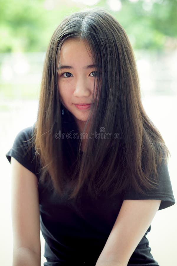 Portrait Headshot Of Beautiful Asian Teenager Looking With Eyes Contact